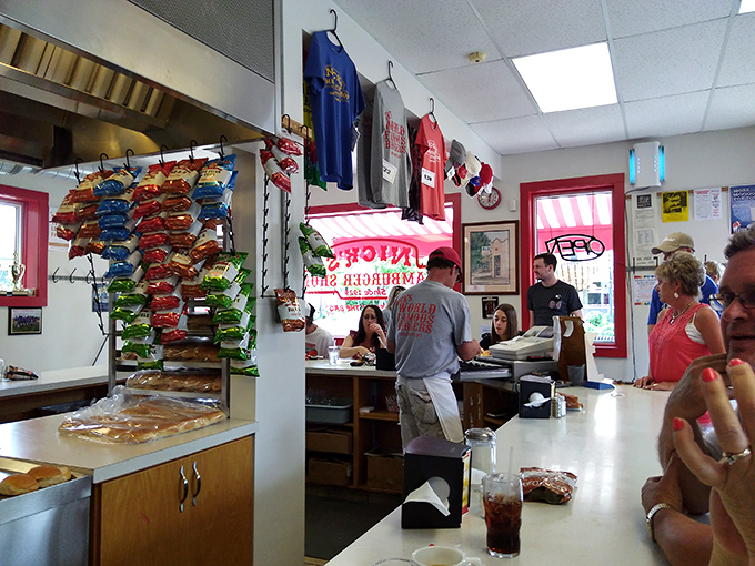 The grill master at work, surrounded by appreciative diners. In the church of burgers, this is where the magic happens.