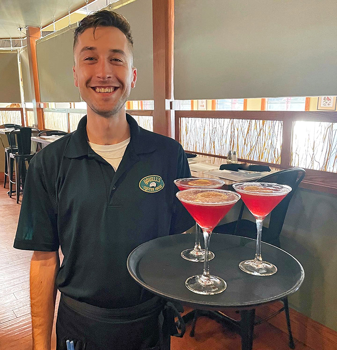 Service with a genuine smile makes everything taste better. This staff member's enthusiasm for those colorful martinis is exactly what hospitality should look like.