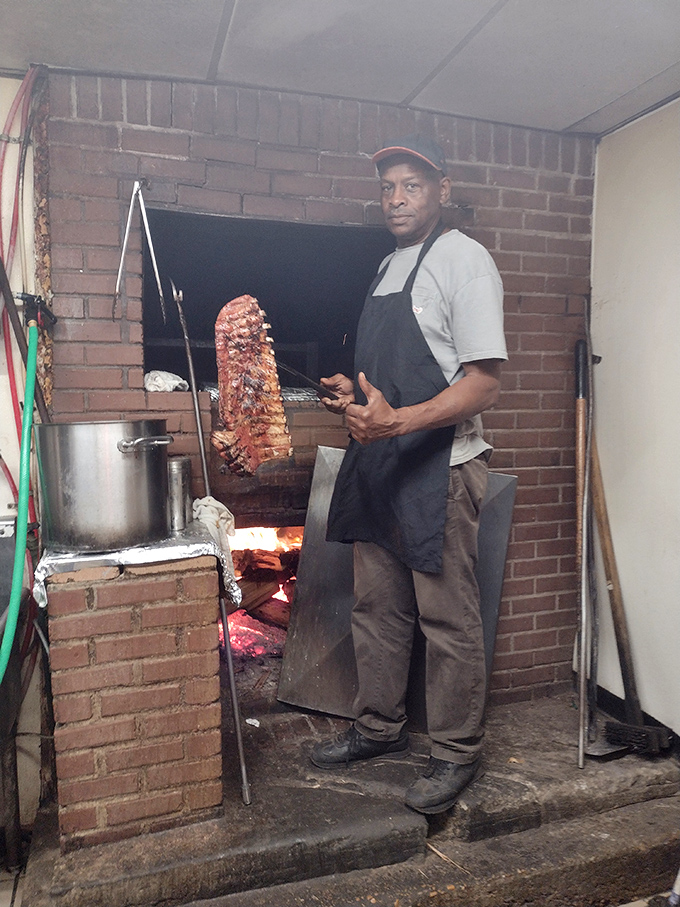 The pitmaster at work: This is where the magic happens, with techniques passed down through generations creating that signature Dreamland flavor.