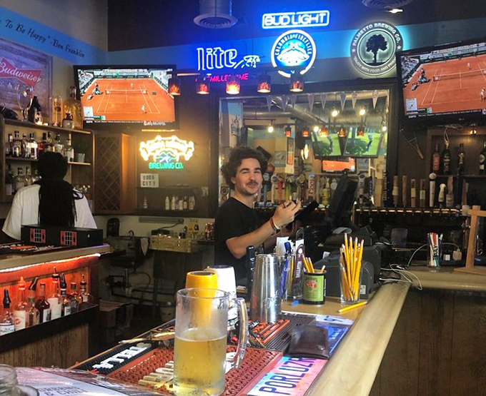 Behind the bar, where liquid magic happens. The neon glow promises cold drafts and the bartender's smile guarantees good conversation.