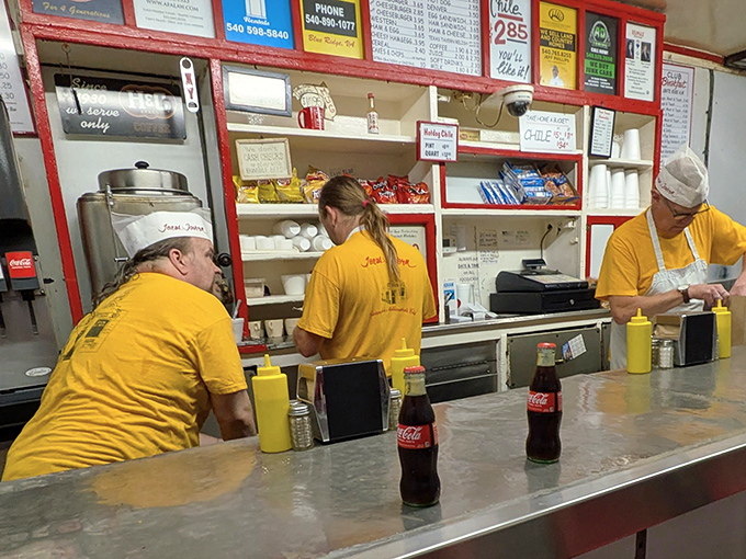 The staff, dressed in sunny yellow, orchestrates the tavern's symphony of sizzles and satisfied sighs with practiced precision.