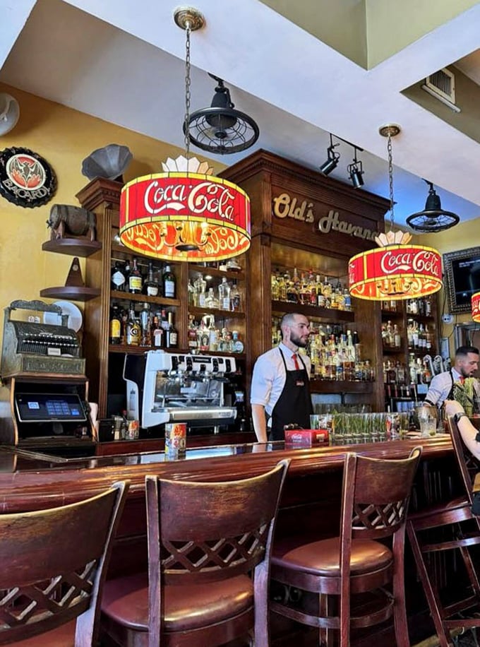 The bartenders move with the practiced precision of people who know their mojitos aren't just drinks, but liquid ambassadors of Cuban culture.