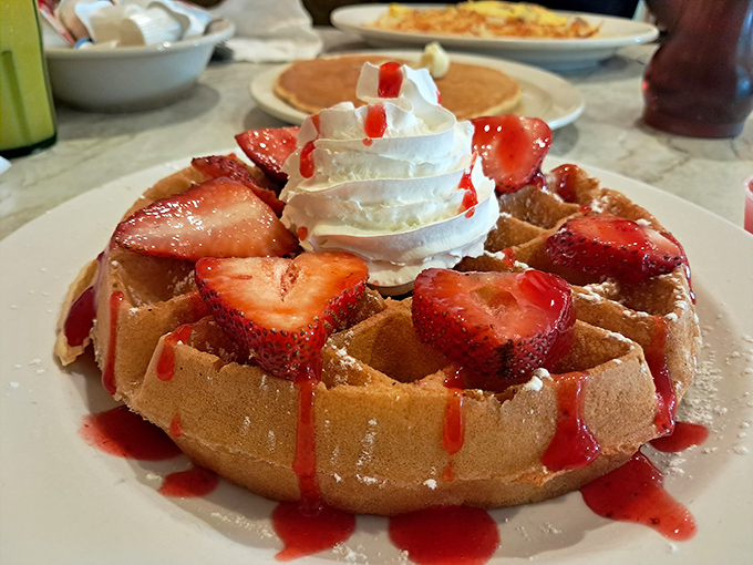 This waffle isn't just breakfast, it's dessert with an alibi&mdash;crispy, fluffy, and adorned with strawberries and whipped cream like a crown jewel.
