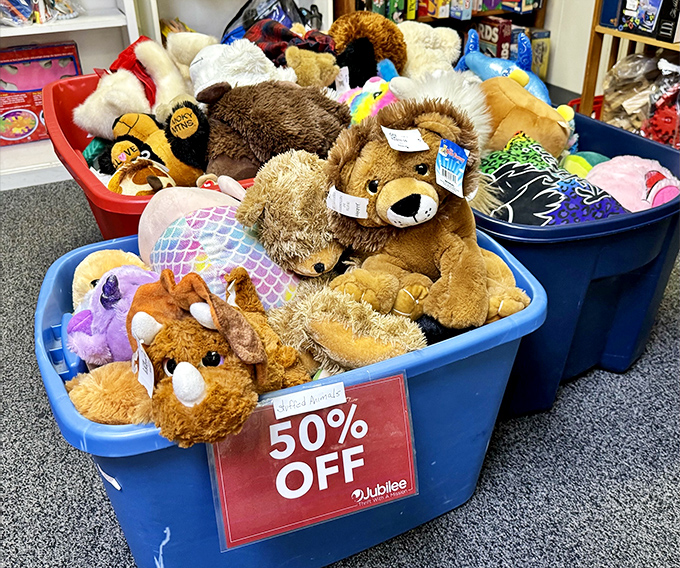 Stuffed animals huddle together in blue bins, like adorable refugees seeking forever homes and bedtime cuddles.