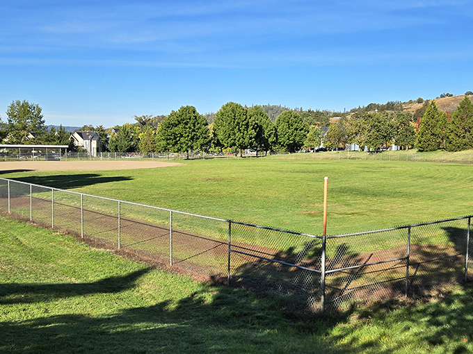 Sunshine Park's baseball field awaits community games where nobody keeps score but everyone remembers the laughs for years.