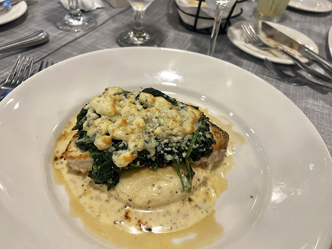 This white fish crowned with spinach and cheese doesn't just sit on the plate—it floats on a cloud of creamy sauce worthy of seafood royalty.