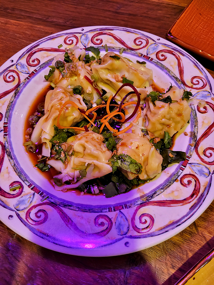 Dumplings so delicate they practically whisper when you bite into them. The sauce underneath is collecting flavor autographs from every ingredient.