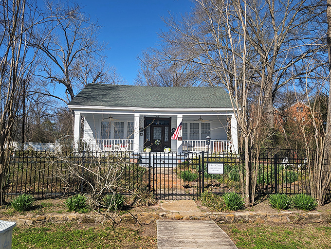 This unassuming cottage holds secrets and stories behind its white picket fence, inviting curious visitors to discover its past.
