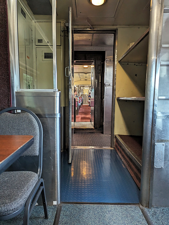 Narrow passageways between train cars reveal the elegant functionality of vintage rail design&mdash;every inch purposeful, every detail considered.