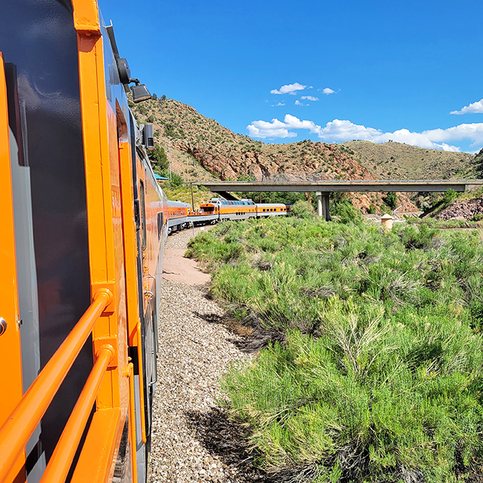 Looking out from the train reveals the serpentine path ahead, where each curve promises a new postcard-worthy vista of Colorado's rugged landscape.