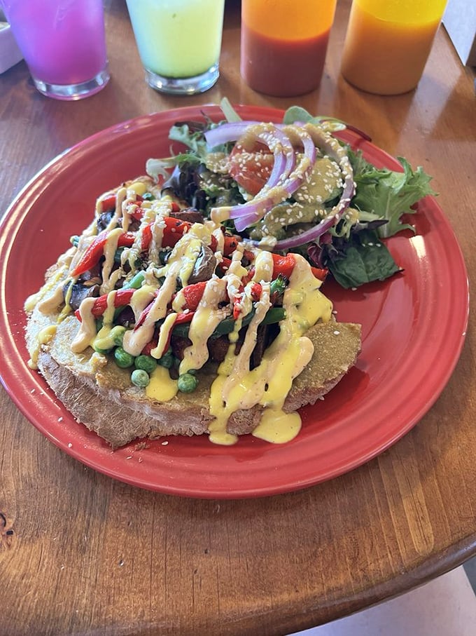This open-faced sandwich wears its vegetables proudly, like medals of honor. That yellow sauce drizzle is the culinary equivalent of a perfect sunset.