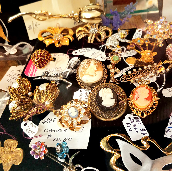 A glittering galaxy of vintage brooches and cameos. Each piece once pinned to someone's Sunday best or treasured as a family heirloom.