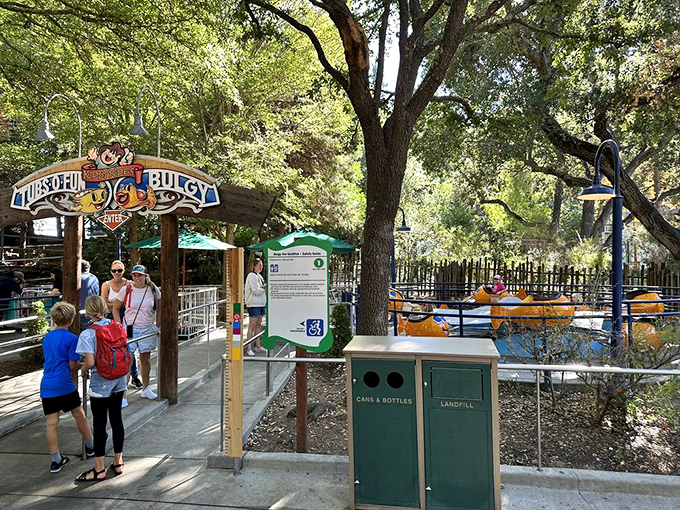 Families navigate the pathways between attractions, creating those in-between moments that often become the most cherished memories of the day.