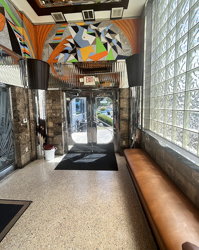 The entrance hallway's geometric art and glass blocks create a surprisingly stylish portal between the ordinary world and diner paradise.