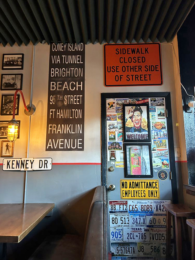 The wall doesn't just display street signs&mdash;it tells stories. Each license plate and sign is like a passport stamp in this culinary journey.