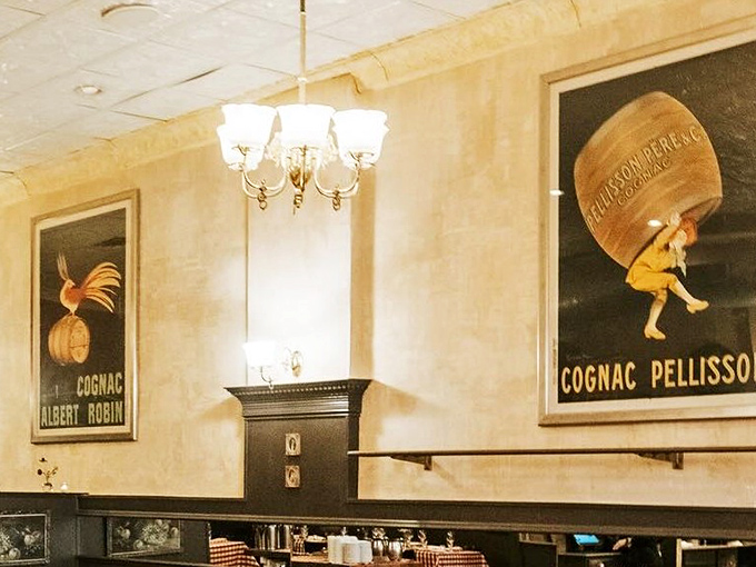 Vintage French posters watch over diners like old friends. That Cognac Pellisson ad has probably witnessed more first dates than a matchmaking service.