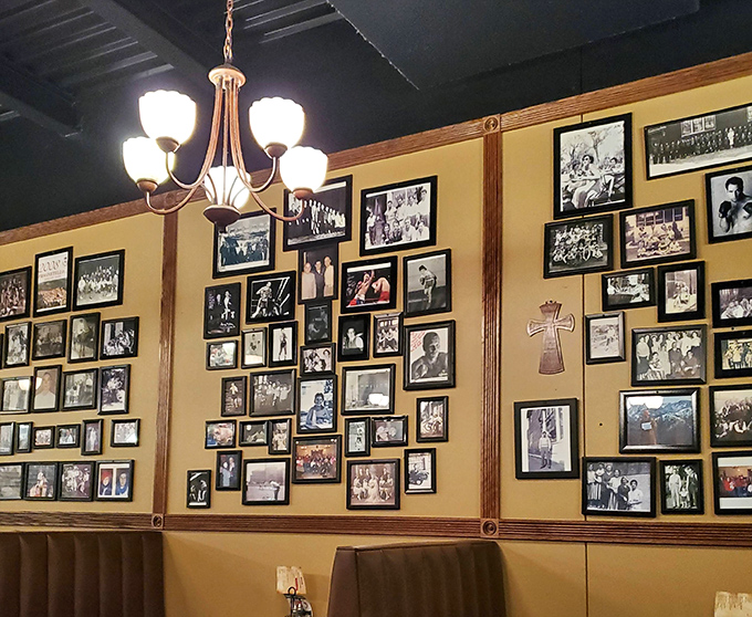 The photo wall of fame, where decades of satisfied customers smile back at you between bites of breadsticks.