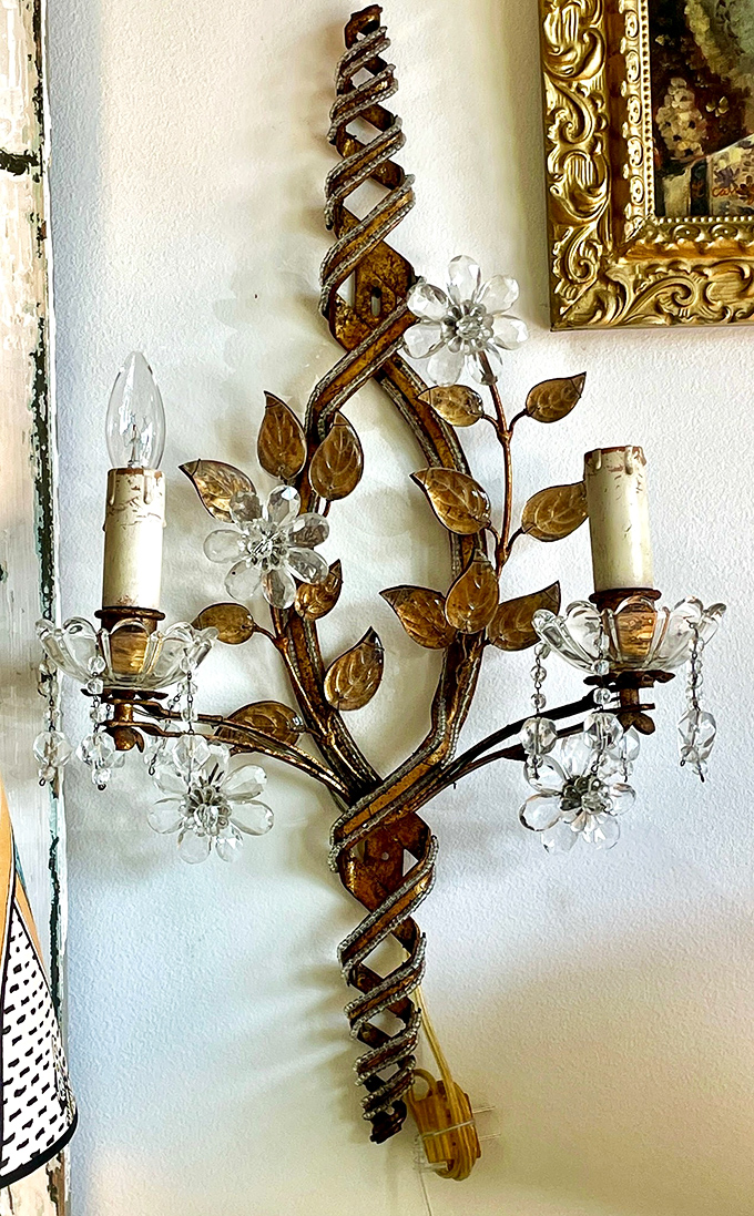 Wall sconces that combine crystal flowers and twisted metal&mdash;like jewelry for your walls that also happens to light them.