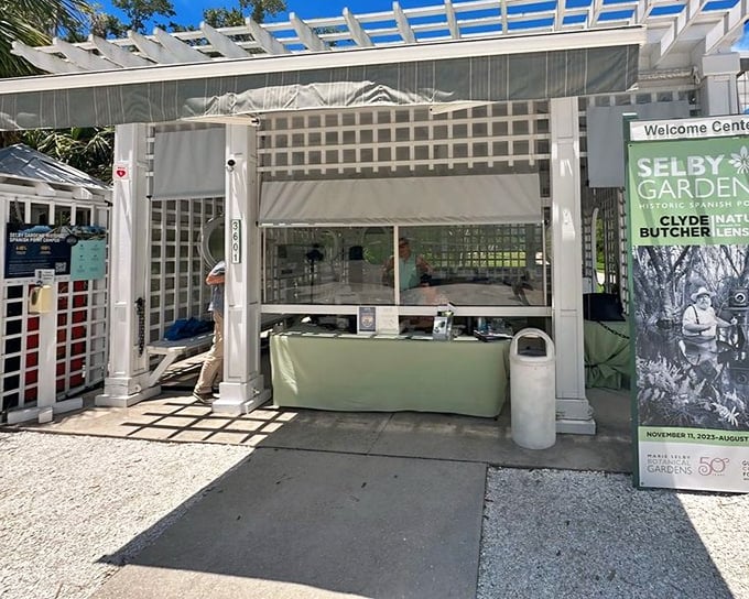 The welcome center greets visitors with clean lines and Florida sunshine, promising botanical adventures just beyond its threshold.