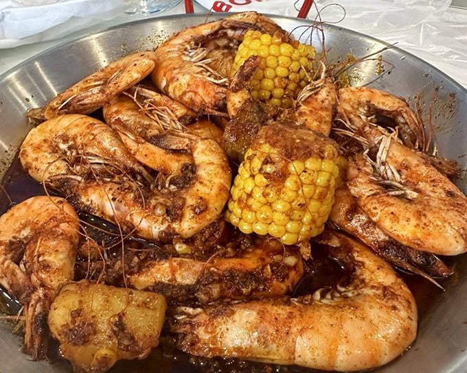 Head-on shrimp swimming in seasoned butter sauce. These aren't just shrimp&mdash;they're an event requiring both hands and zero inhibitions.
