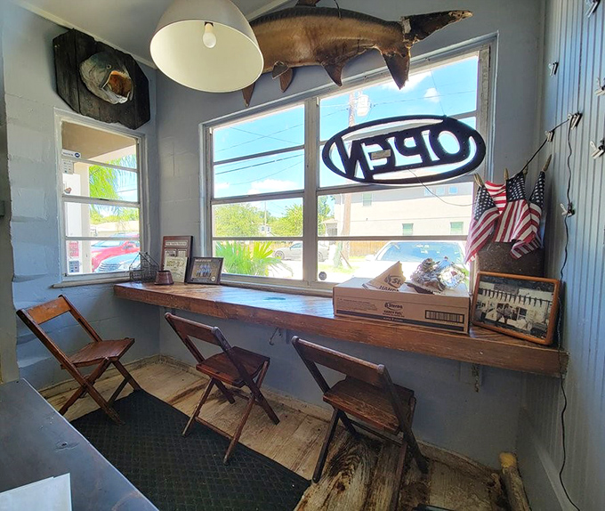 Window seating that lets you people-watch while you feast. That mounted fish overhead is either judging your order or approving it.