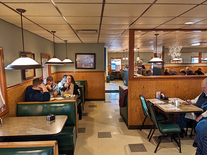 Green booths and wood dividers create those semi-private dining universes where families have been solving the world's problems for decades.
