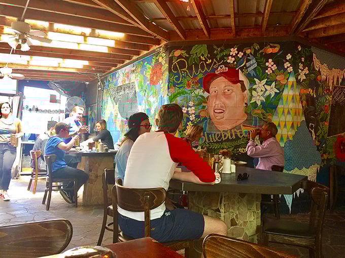 The colorful mural serves as both art and appetite stimulant, creating the perfect backdrop for morning conversations and coffee revelations.