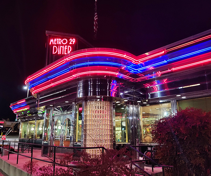 At night, the neon glow of Metro 29 Diner transforms it into a beacon of hope for the hungry, like a lighthouse for comfort food seekers.