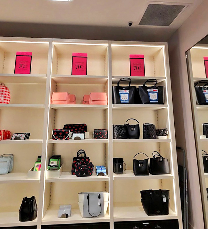 Kate Spade's handbag display showcases the perfect balance of sophistication and whimsy, where 70% off signs trigger spontaneous joy.