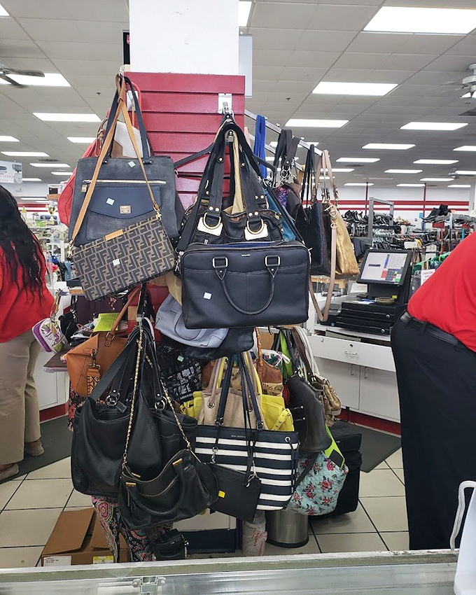 Handbag heaven hanging in organized chaos. That designer tote for the price of a sandwich? This is why thrift hunters get up early.