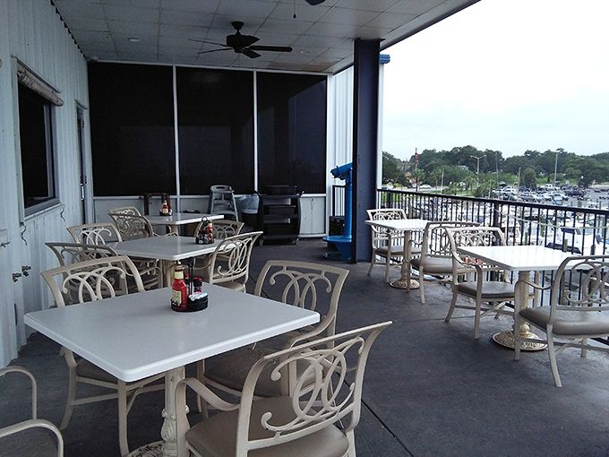 Outdoor dining with a harbor view&mdash;where the gentle Gulf breeze serves as both seasoning and air conditioning.