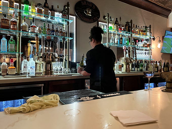 The bar at Shaw's isn't just stocked &ndash; it's a liquid library of possibilities, with bottles glowing like treasures in a cave.