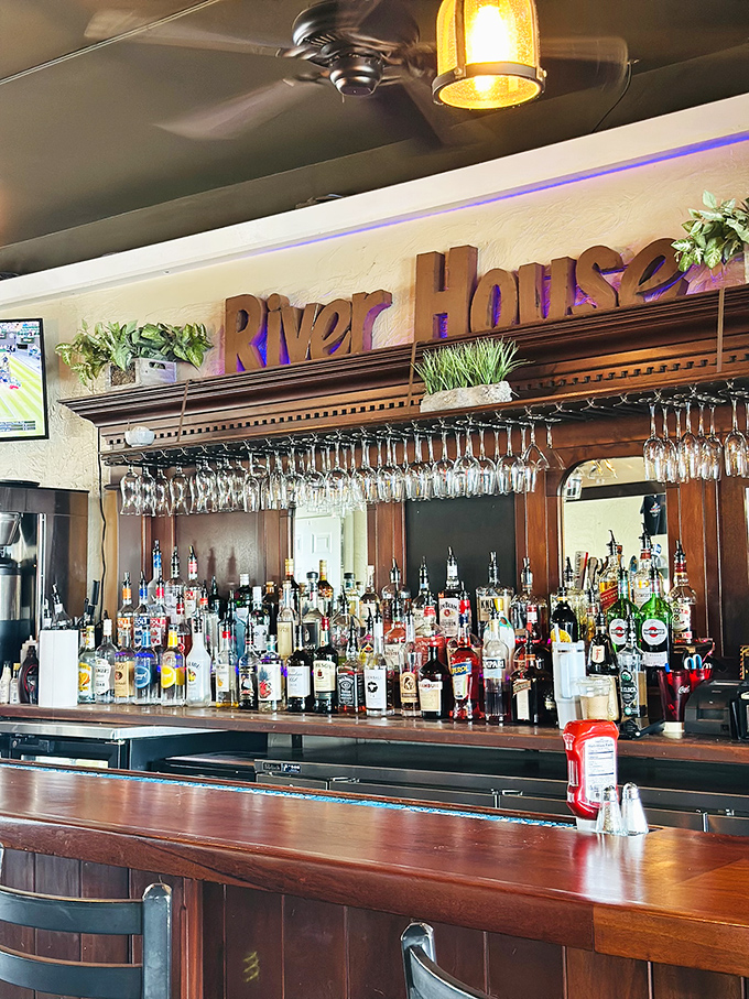 The bar area balances rustic charm with polished service. Those hanging glasses are just waiting to be filled with something celebratory.