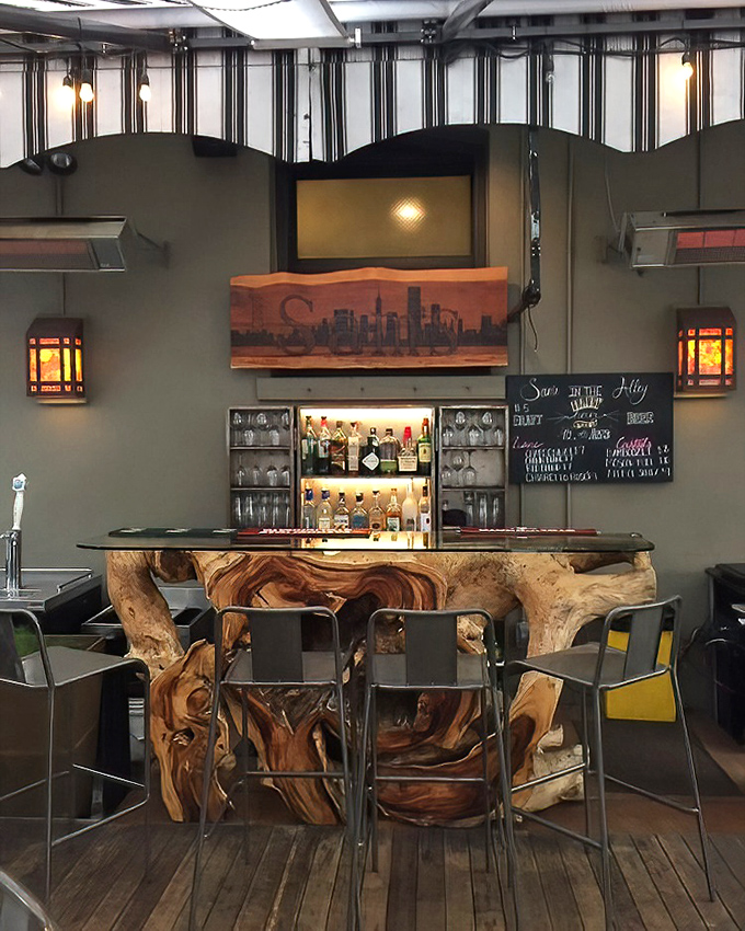 The bar area offers a glimpse of San Francisco's artistic side, where live-edge wood meets craft cocktails in surprising harmony.