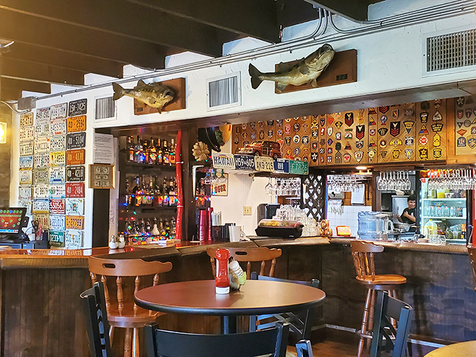 The bar area showcases Florida's obsession with license plates and fishing trophies. Every surface tells a story&mdash;some taller than others.