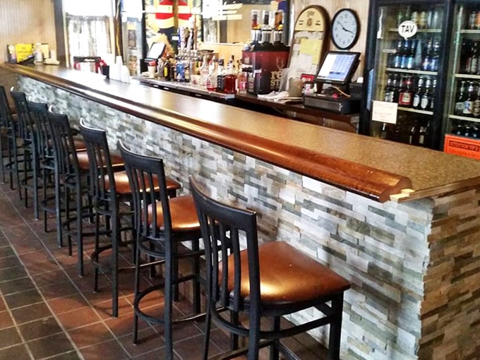 A bar that understands the importance of elbow room and cold beer. That stone facade isn't just pretty&mdash;it's supporting countless stories.