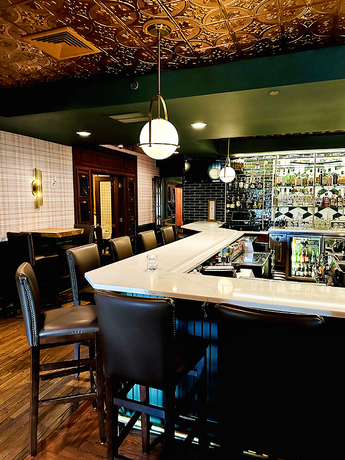 Another angle of the bar reveals more of its character. The ceiling tiles catch light like gold, setting the mood for sophisticated sipping.