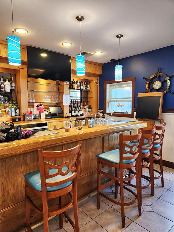 The bar area—where maritime meets mixology under blue pendant lights that mimic the gentle waves outside.