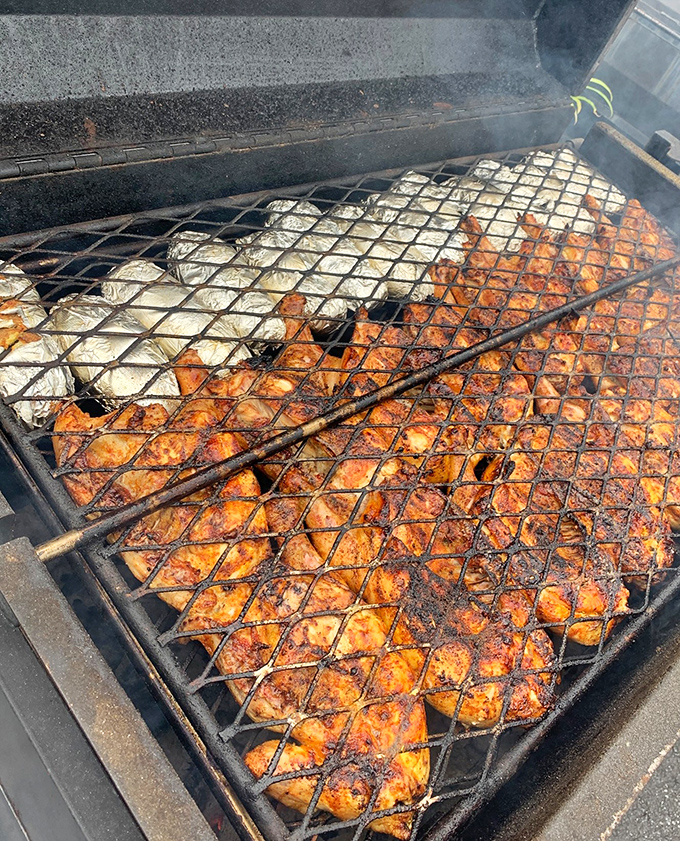 The smoker where flavor is born. Those chicken pieces aren't just cooking&mdash;they're transforming into something transcendent.