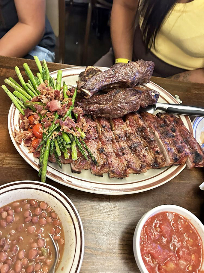 When meat becomes art: ribs, steak, and asparagus sharing a plate like old friends at a reunion. Those beans are no afterthought.