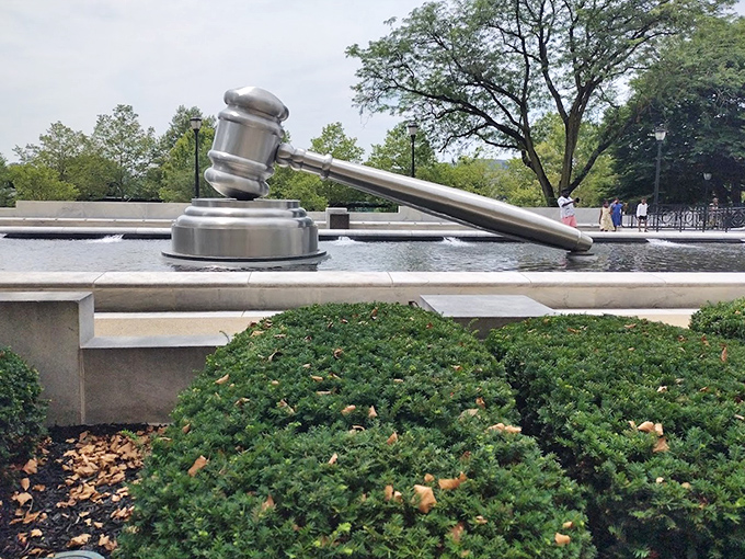 Peeking above the manicured shrubs, the gavel seems to play a game of hide-and-seek with visitors&mdash;though at this size, it's not exactly hiding well.