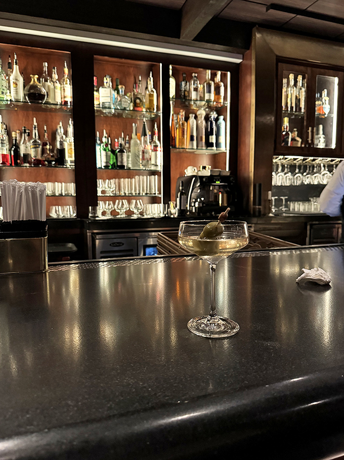 The bar beckons with bottles lined up like soldiers, ready to deploy in service of your perfect Manhattan or martini.