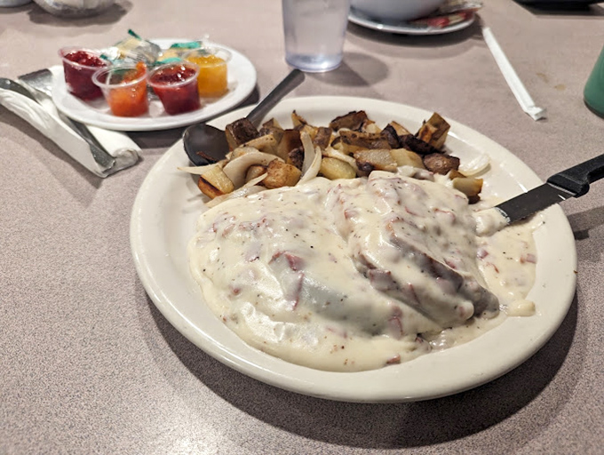 Biscuits and gravy that would make any Southern grandmother nod in approval &ndash; a creamy, peppery blanket of comfort atop pillowy baked perfection.