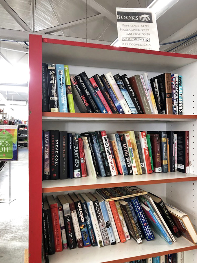 Hardcovers and paperbacks line these shelves like literary lottery tickets—each spine a potential jackpot of entertainment for less than a latte.