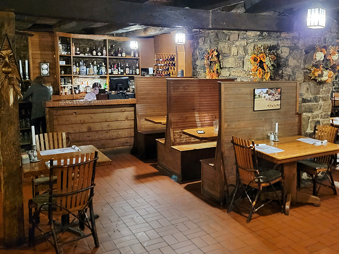 Cozy wooden booths create intimate dining spaces where you can imagine revolutionaries once plotted independence over hearty meals and strong spirits.