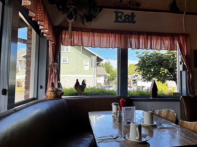 Red checkered curtains and chicken figurines create that perfect diner atmosphere where "Eat" is both decoration and directive.