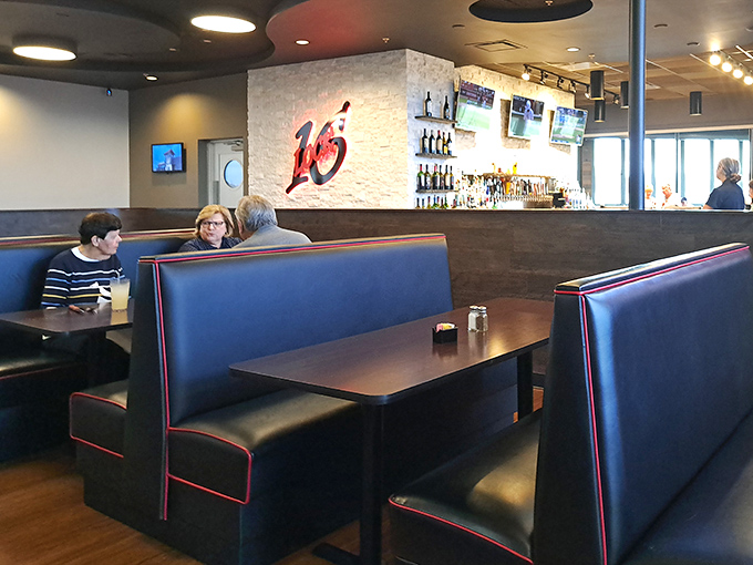 Navy blue booths with racing-stripe red trim nod to the restaurant's logo. The perfect setting for that moment when the conversation is as good as the food.