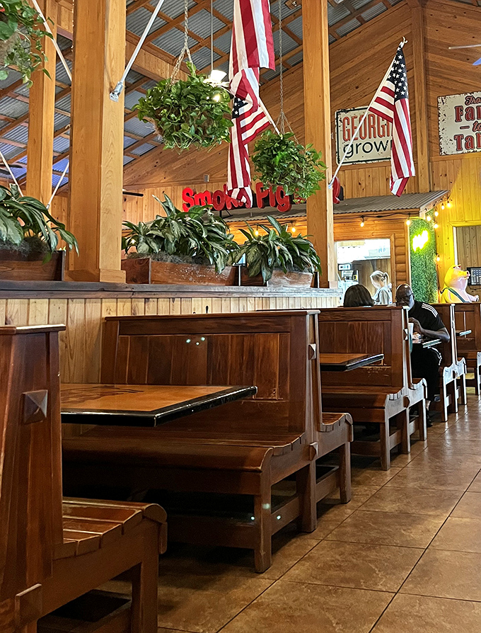 Church pew-style booths under American flags &ndash; dining with patriotic purpose. The wooden interior whispers, "Stay awhile, y'all."