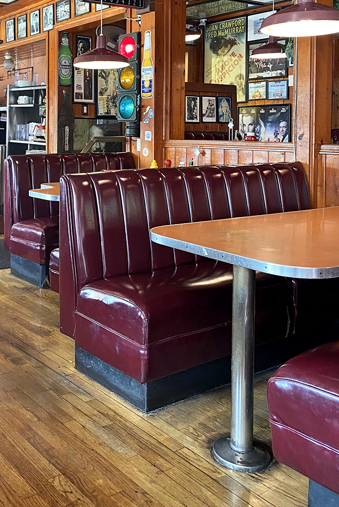 Burgundy vinyl booths that have cradled countless conversations, first dates, and food comas through the decades.