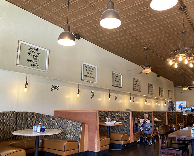 Cozy booths where countless family stories have unfolded over plates of eggs and pancakes, under the gentle glow of pendant lights and inspirational wall art.